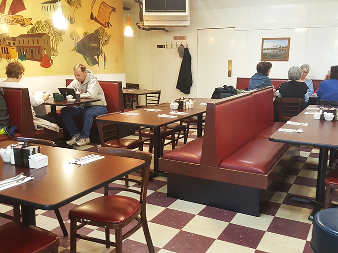 Where strangers become neighbors over coffee. In the church of breakfast, these red vinyl pews host the faithful seeking salvation in syrup.