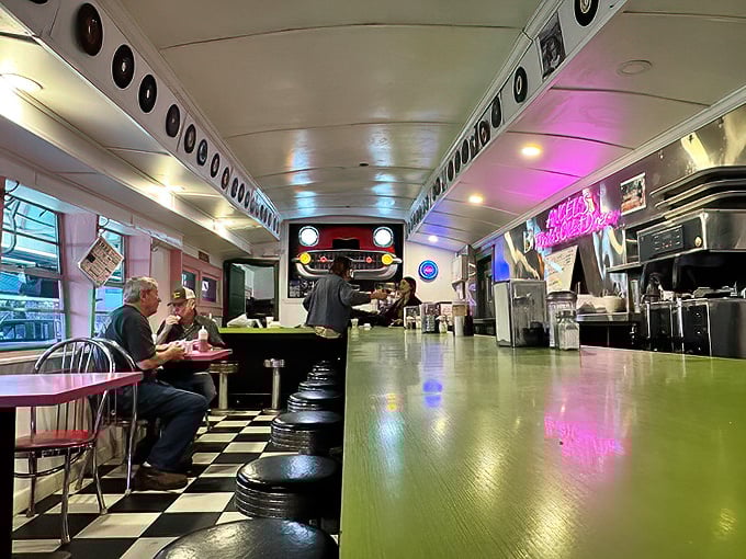 Where conversations flow as freely as the coffee. The green counter gleams like the dashboard of a vintage Cadillac.
