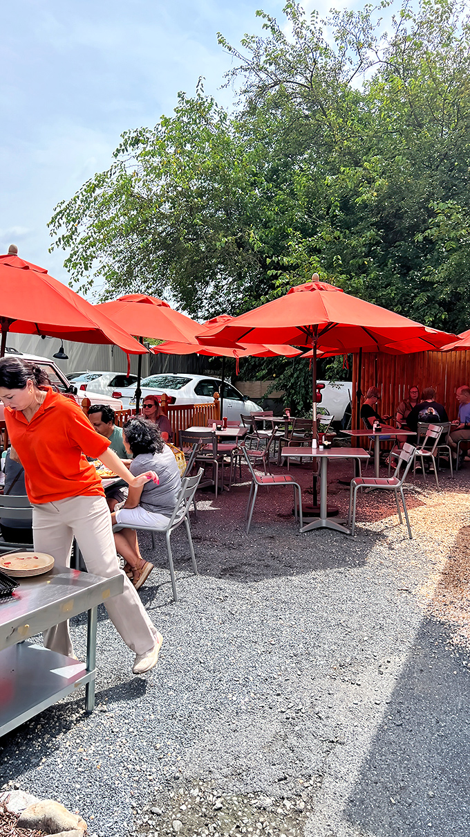 Outdoor dining under bright orange umbrellas—like eating breakfast in a cheerful poppy field, but with better service and no flying monkeys.