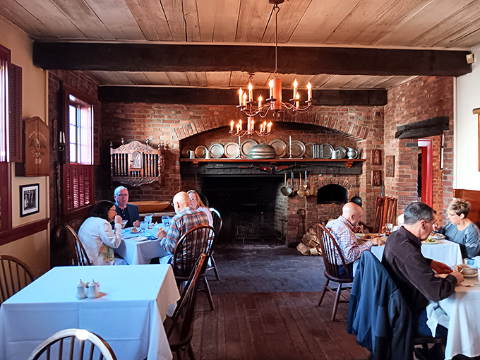 Where hearty meals meet hearth-side comfort. The massive brick fireplace isn't just for show – it's the soul of this historic dining space.