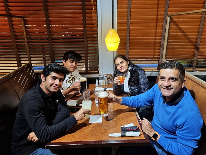 Happy diners raising glasses in that universal gesture that says, "This place was absolutely worth finding."