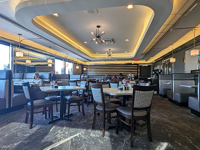 Modern elegance meets classic diner comfort in this dining area. The ceiling lighting could double as modern art in a fancy museum.