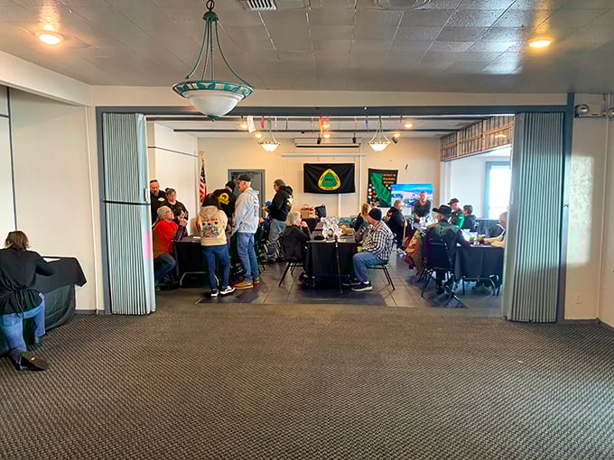 The banquet room buzzing with conversation—where strangers become temporary friends united by their mutual appreciation for good food and river views.