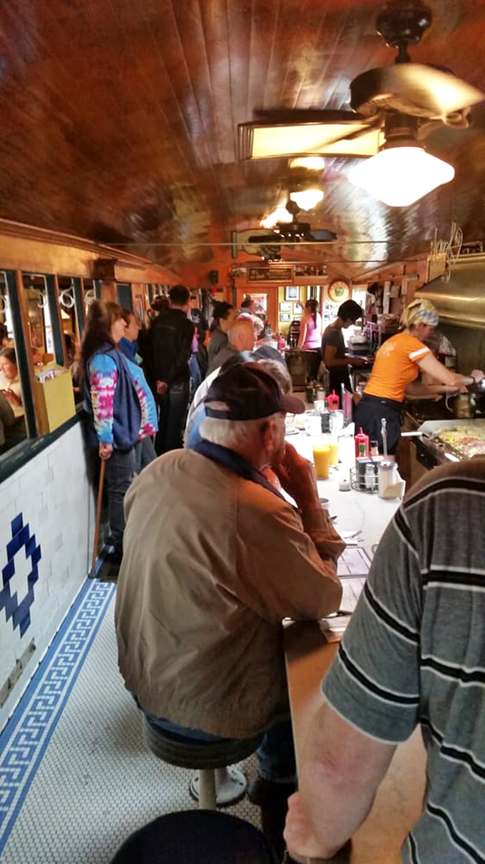 The narrow dining car fills with humanity each morning—strangers becoming temporary neighbors united by the universal language of good food.
