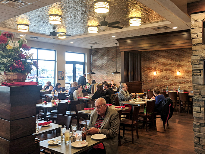 The dining room buzzes with that perfect energy—where everyone from first dates to regulars celebrating their 50th anniversary feels equally at home.