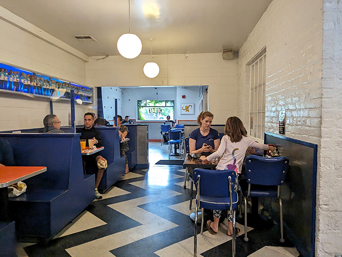 The chevron floor leads your eye to what matters: people enjoying real food in a space where conversation flows as freely as the coffee.
