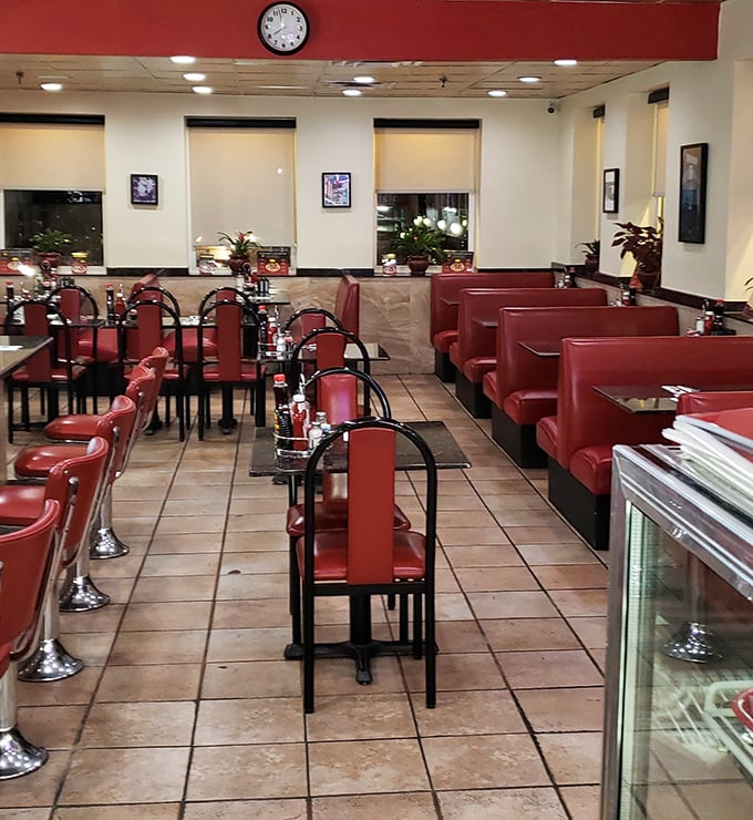 The empty dining room, set and waiting like a stage before a performance. Red vinyl booths standing at attention, ready for their daily parade of humanity.
