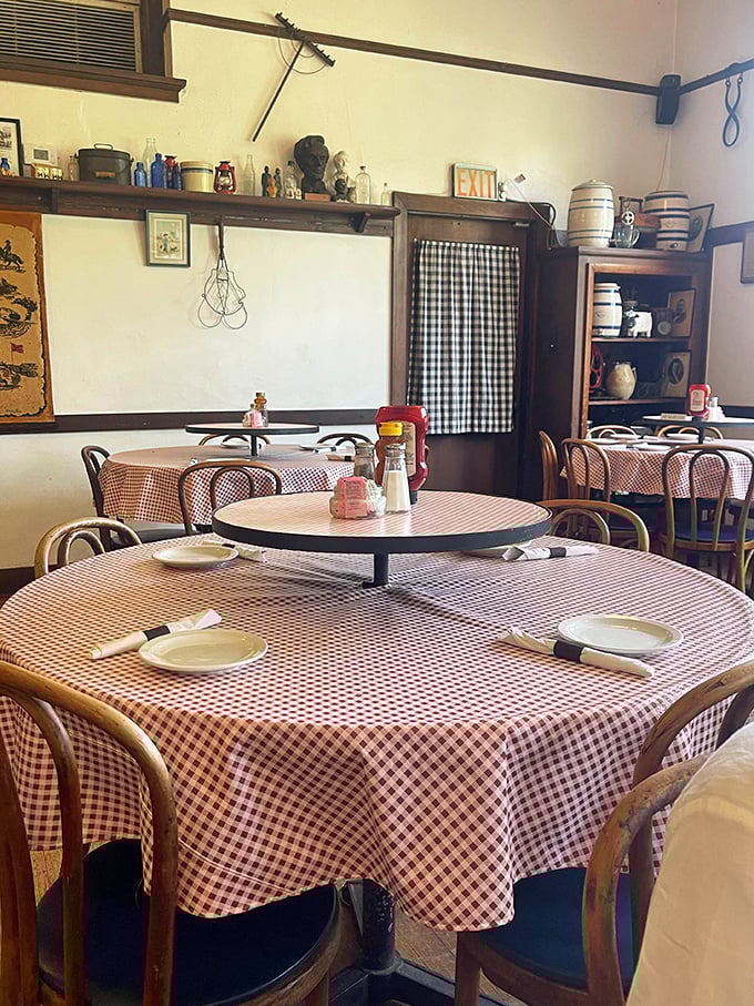 Exposed beams and vintage schoolhouse charm create an authentic dining room where history meets exceptional homestyle cooking today.