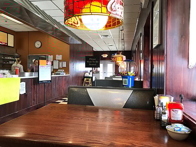 Stained glass lamps cast a warm glow over wood-paneled walls. This isn't designed nostalgia—it's the real deal, earned one meal at a time.