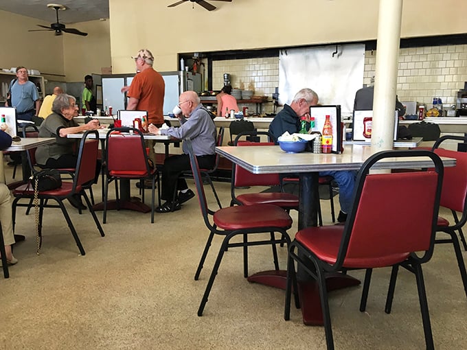 Classic diner atmosphere where every seat offers front-row access to breakfast theater magic.