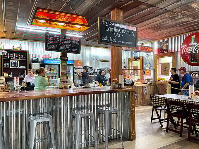 The counter service area doubles as a stage where barbecue theater unfolds. Notice the vintage Coca-Cola light fixture – a Southern dining requirement.