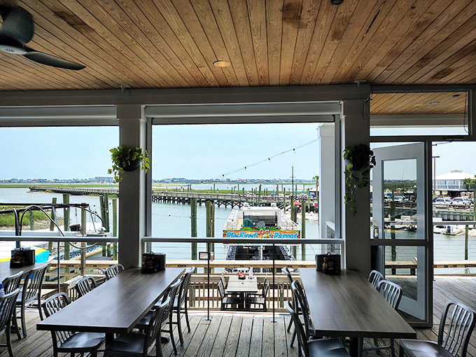 Dining with a view that rivals the food—expansive windows frame the marshland and docks, nature's perfect backdrop for seafood feasting.