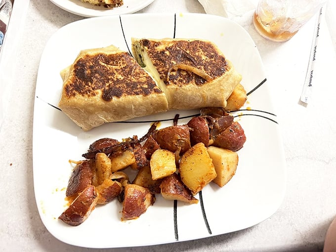 This breakfast wrap and potatoes combo isn't just a meal—it's fuel for conquering the day, with each bite delivering a perfect balance of textures.