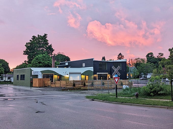 Sunset paints the sky pink behind this modern brewery, proving Petoskey balances tradition with contemporary pleasures like craft beer and outdoor patios.