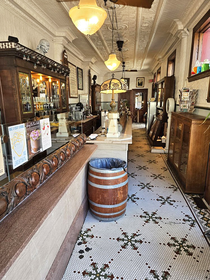 The mosaic floor tells you this place takes tradition seriously. That wooden barrel isn't decorative—it's a statement about doing things the old way.
