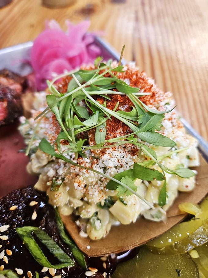 Esquites elevated with fresh herbs and a dusting of spice—proof that sides at Moo's aren't afterthoughts but co-stars.