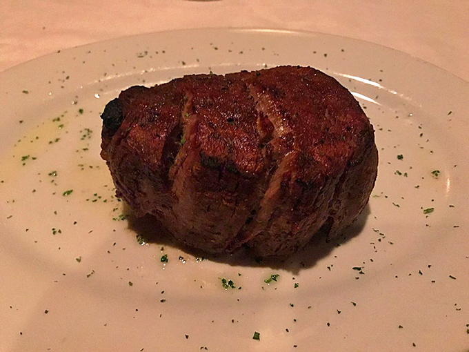 This filet mignon sits like royalty on the plate – a testament to the simple perfection of prime beef cooked by people who respect it.