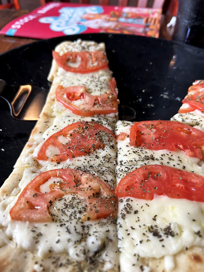 Pizza that doesn't need to shout to get your attention – just fresh tomatoes, melty cheese, and herbs on a perfectly crisp crust.