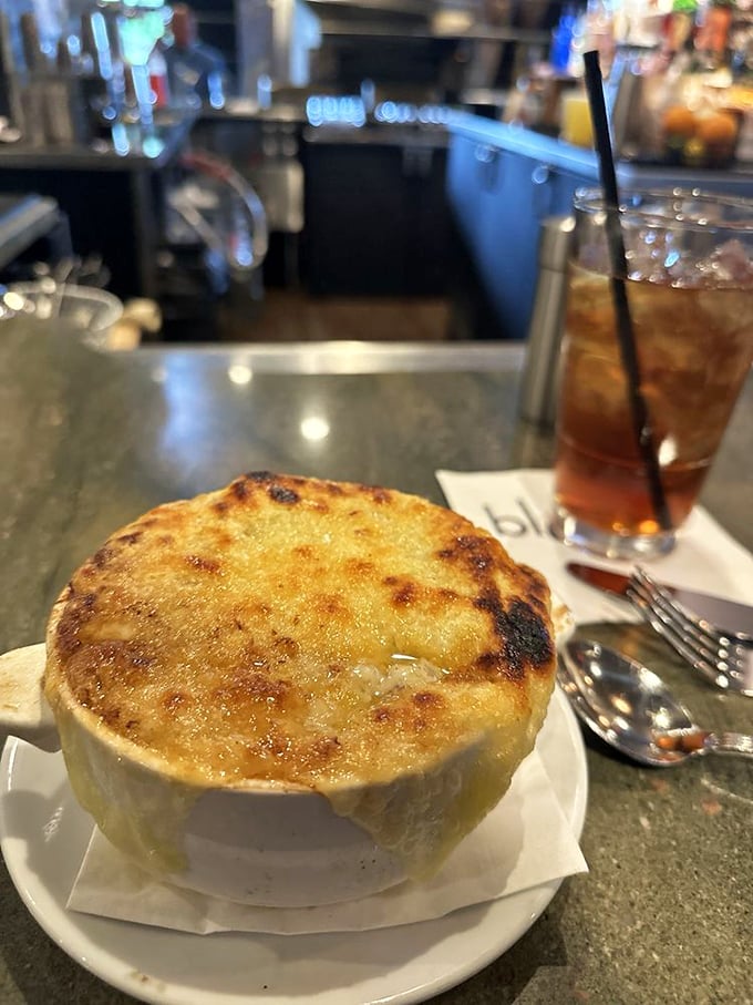 French onion soup that's had a proper education—bubbling cheese, rich broth, and a commitment to comfort that's downright inspirational.