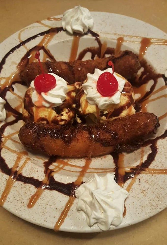 Dessert that laughs at restraint. Fried bananas with ice cream, whipped cream, and cherries—because after smoked meat, why start being sensible now?