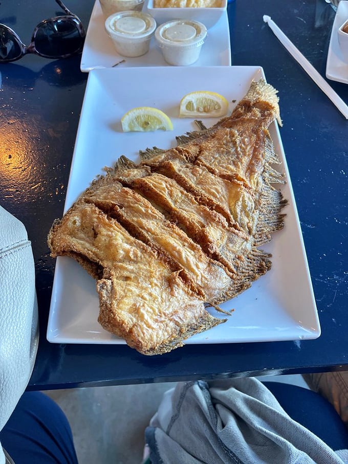 Fried flounder that's achieved the impossible balance—delicately crisp exterior giving way to flaky, tender fish that tastes like it jumped from water to fryer.