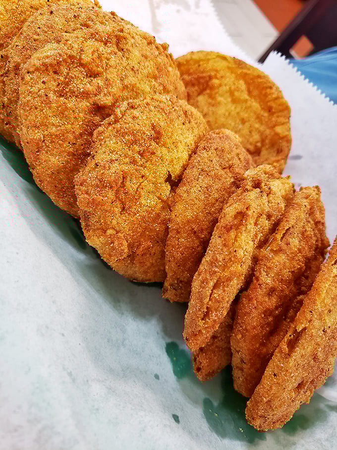 Golden discs of Southern ingenuity—fried green tomatoes that balance tartness and crunch in perfect harmony.