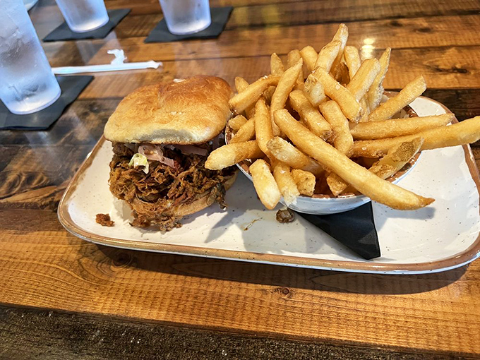 Golden fries alongside a sandwich that's practically collapsing under the weight of its own deliciousness – a perfect partnership.