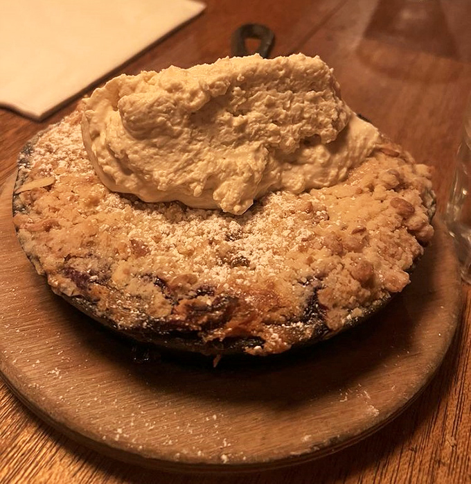 A fruit cobbler that makes you question why you ever bothered with fancy desserts – homestyle crumble topping and what appears to be fresh whipped cream.