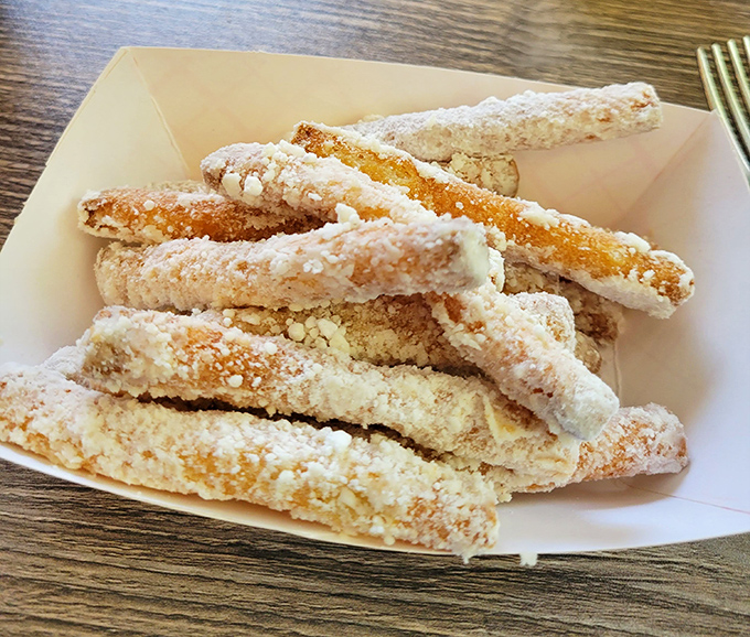 Funnel cake fries dusted with powdered sugar—proof that state fair magic can be enjoyed year-round without having to pay for parking or ride tickets.