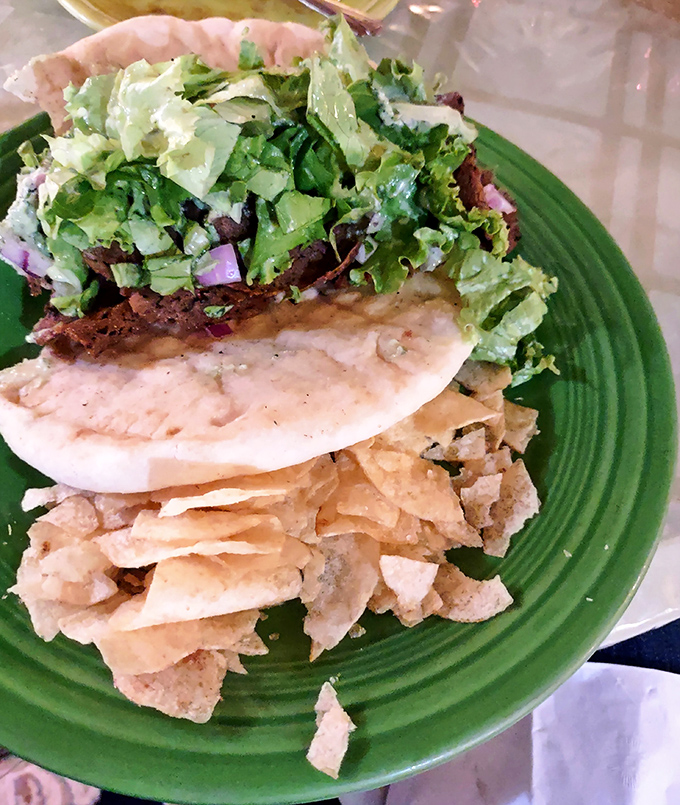 This isn't just a sandwich—it's architecture. Layers of plant-based goodness stacked high enough to require a game plan before the first bite.