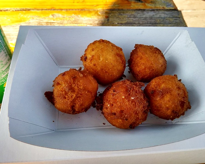 Golden-fried hush puppies that would make your Southern grandmother weep with joy. Crispy outside, tender cornmeal heaven inside.