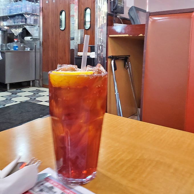 That iced tea looks tall, dark, and refreshing—the kind of drink that makes Maryland summers bearable one sip at a time.