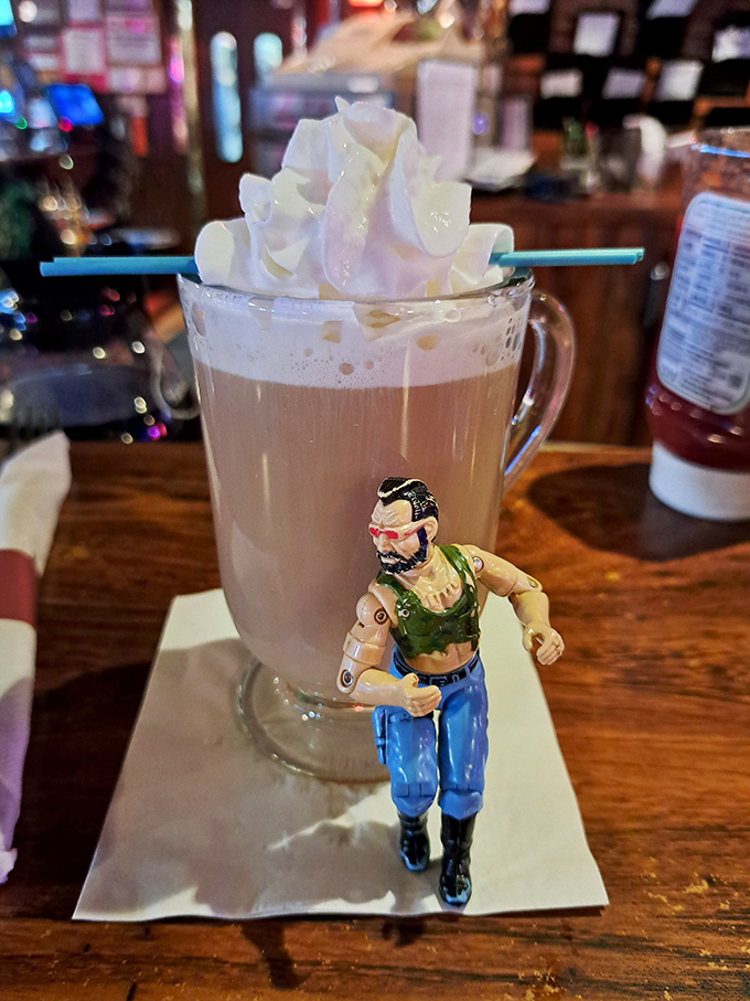 Not just Irish coffee, but a tiny action figure standing guard—because even your morning caffeine deserves its own superhero.
