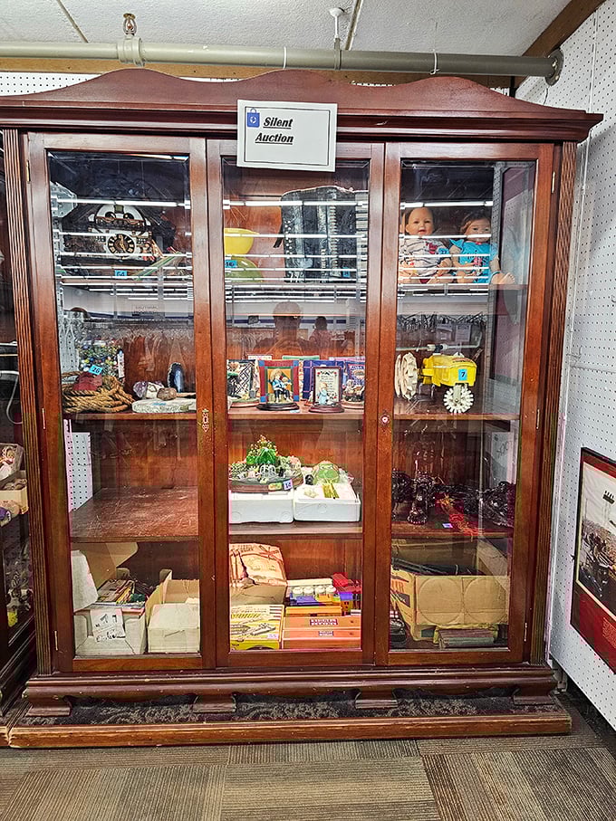 This elegant display cabinet hosts a silent auction of special finds—proof that one person's "finally decluttered" is another's "absolutely must have."