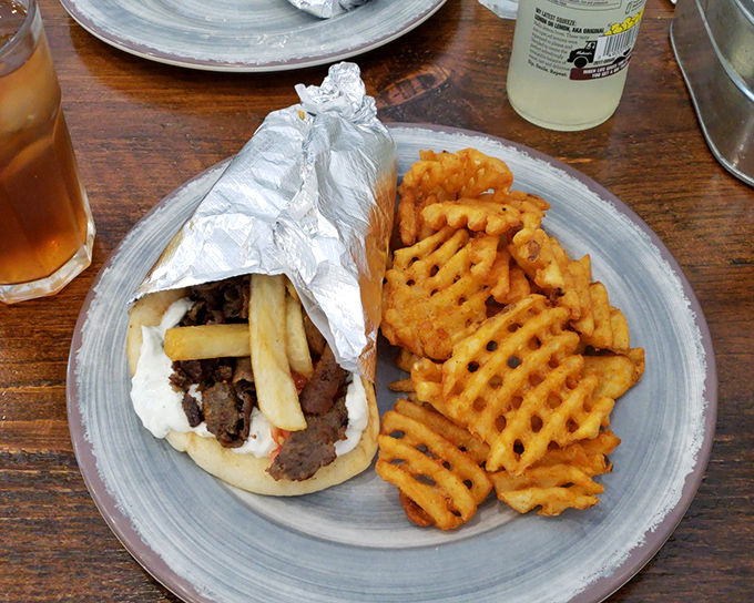 Another angle of gyro greatness—this time with those addictive waffle fries. A meal that satisfies both the inner child and the sophisticated adult palate.