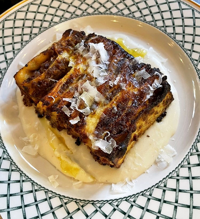 Lasagna reimagined as an architectural marvel – layers of pasta, sauce, and cheese that somehow maintain their distinct personalities.