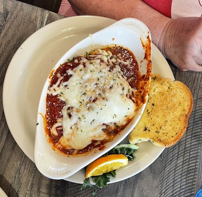 Lasagna that doesn't just sit on the plate—it makes a statement. That garlic toast is the perfect tool for ensuring not a drop of sauce escapes.