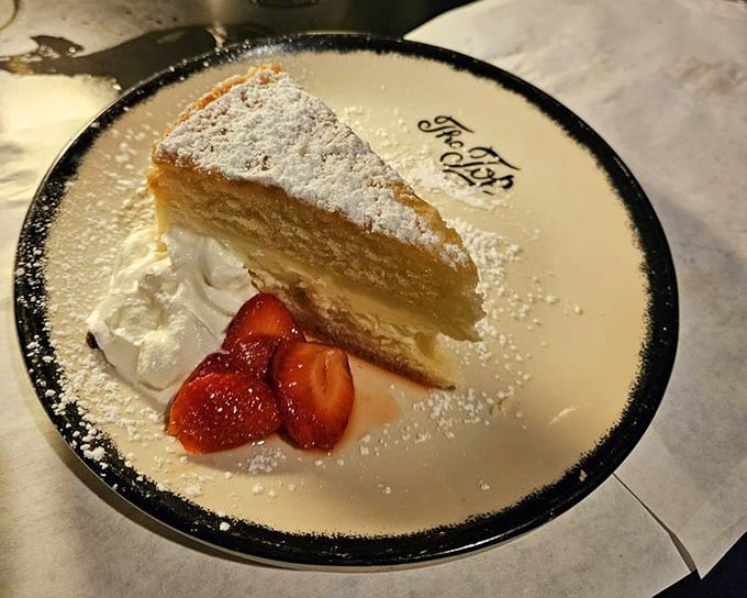 A slice of heaven dusted with powdered sugar. This isn't just dessert—it's the sweet finale to a symphony of flavors.
