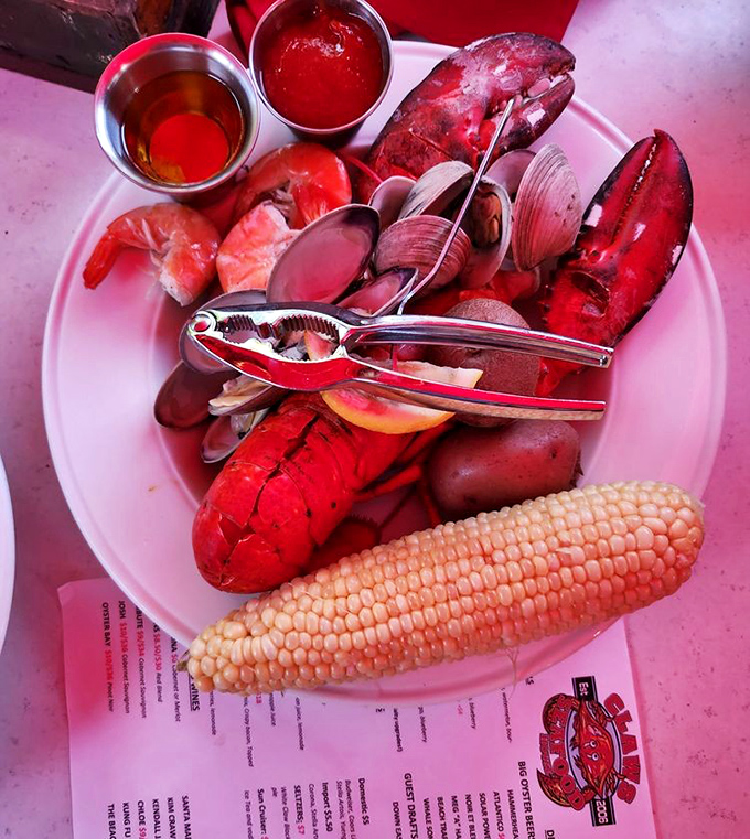 A seafood symphony in red and white. The lobster claw isn't just the star—it's the conductor of this delicious oceanic orchestra.
