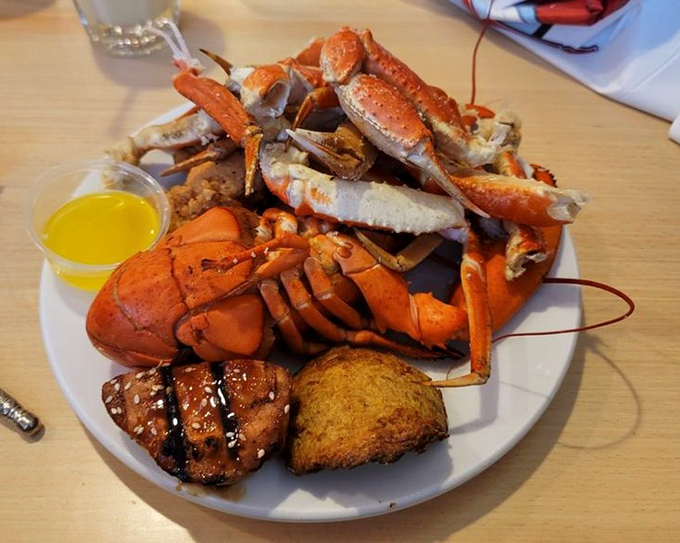 Lobster shell fragments scattered like evidence of a delicious crime scene – the butter cup stands as the only witness.