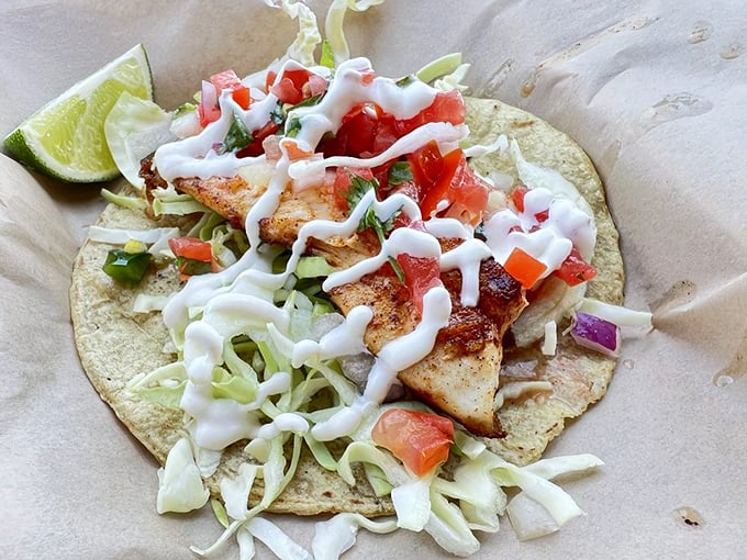 A fish taco that deserves its own sonnet. Flaky fish, crunchy cabbage, and that sauce—oh, that sauce—creating perfect harmony in every bite.