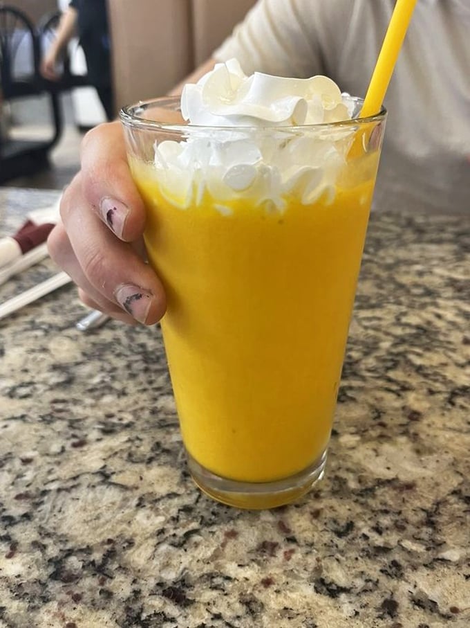 Mango smoothie topped with whipped cream – because sometimes your fruit needs a little celebration on top.