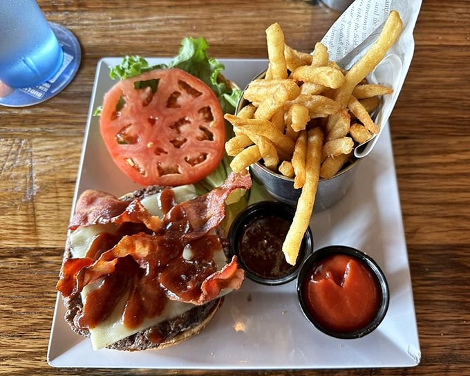 A burger so photogenic it deserves its own Instagram account—thick-cut tomato, crisp lettuce, and a patty that's clearly never met a freezer in its life.