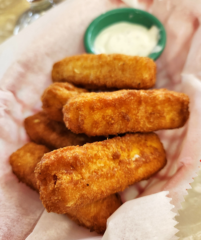 Golden-fried cheese sticks waiting to reveal their molten interior. That first stretchy pull of cheese is more satisfying than any yoga class you've ever taken.