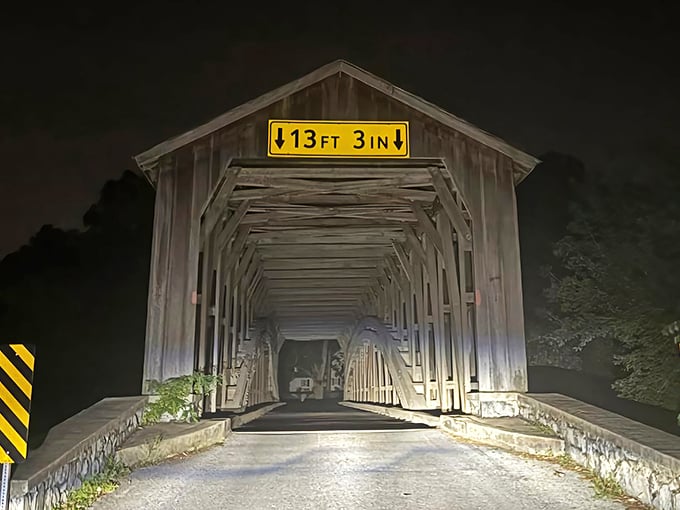 As darkness falls, the bridge becomes even more mysterious—its illuminated tunnel beckoning night travelers like a portal to another time.
