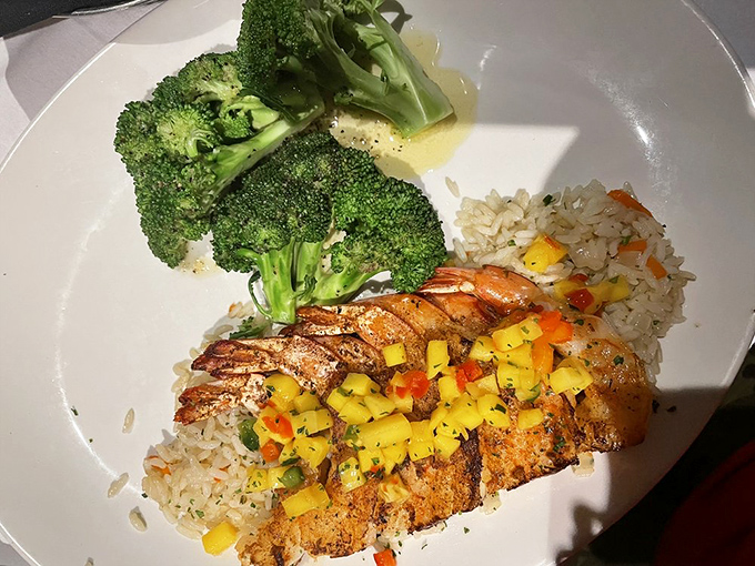 Grilled shrimp with mango salsa and rice – proof that not everything at a steakhouse needs to moo first to be memorable.