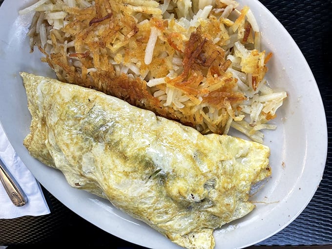 An omelet that defies physics—somehow both fluffy and substantial. Paired with hash browns crisped to golden perfection.