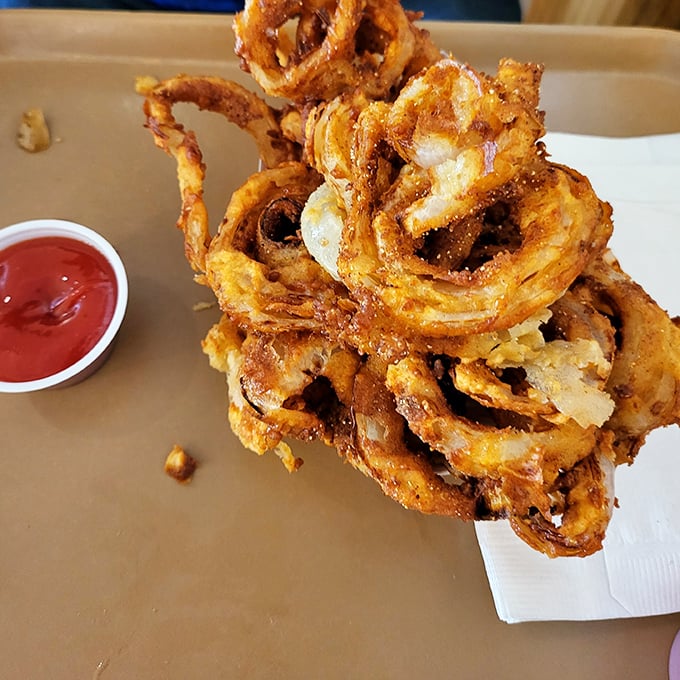 These aren't just onion rings – they're golden halos of perfectly fried goodness that make you question why you'd ever waste time on lesser sides.