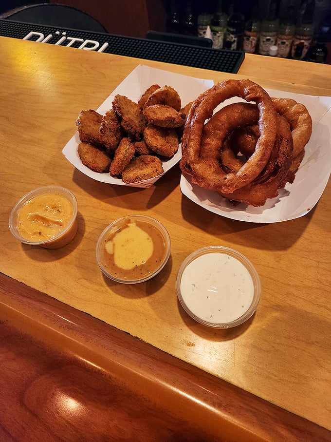 Onion rings and dipping sauces engaged in a perfect culinary tango. These golden hoops aren't just appetizers—they're edible jewelry for your taste buds.