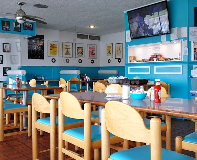 Wooden chairs, vintage posters, and turquoise accents—this isn't interior design, it's a love letter to the golden age of roadside dining.